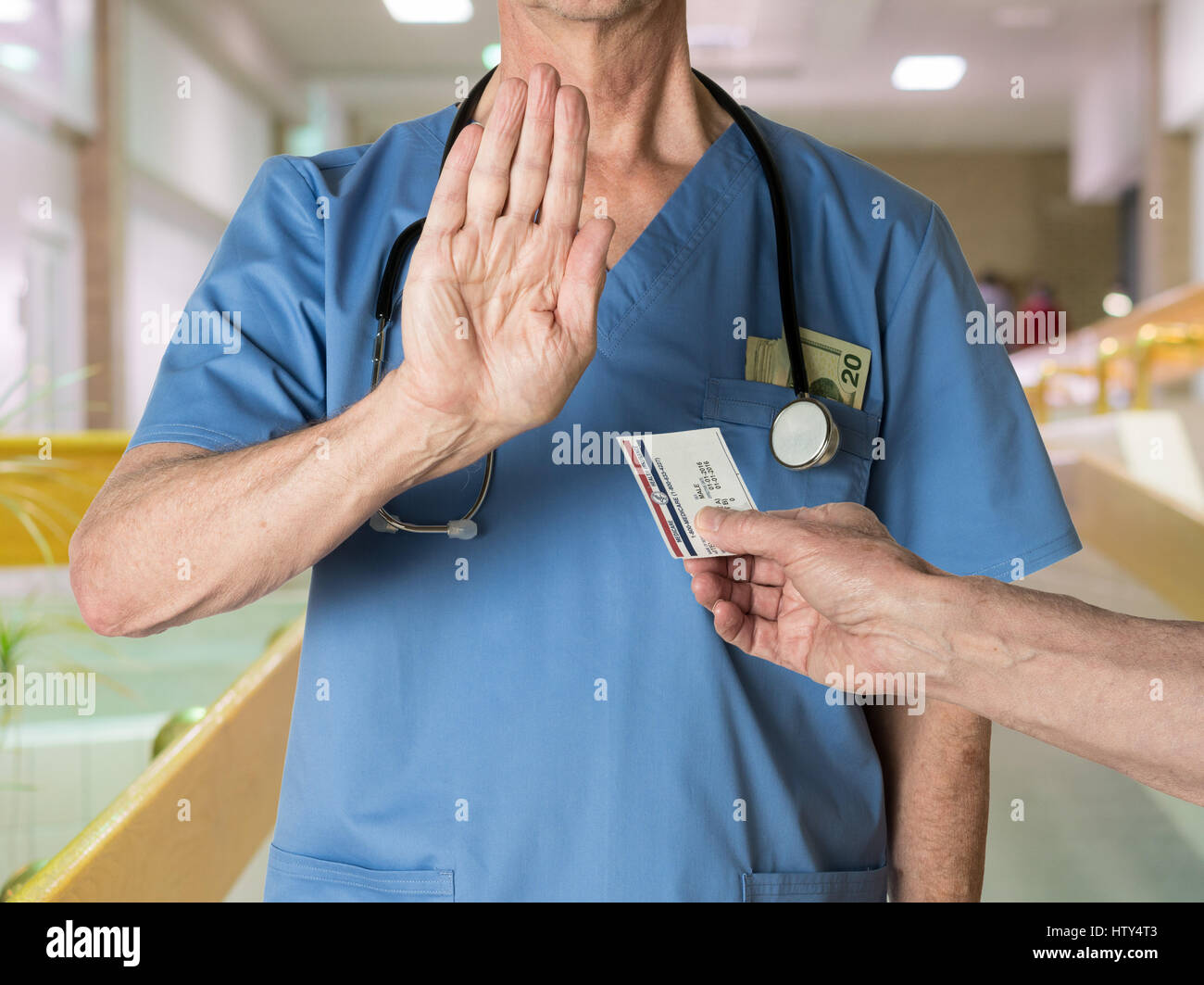 Senior doctor in scrubs refusing Medicare Card Stock Photo - Alamy