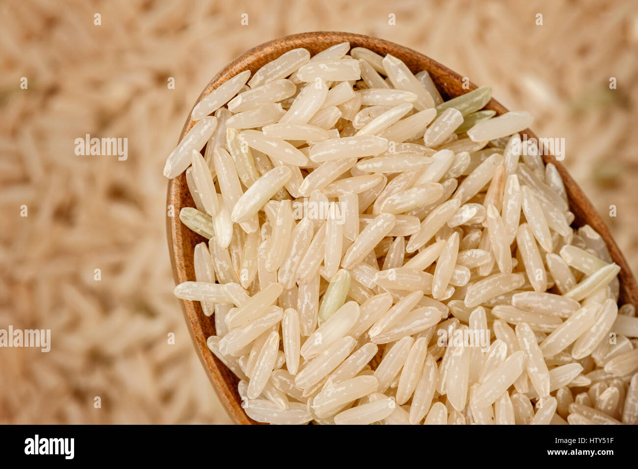 brown rice on wooden spoon, healthy eating Stock Photo - Alamy