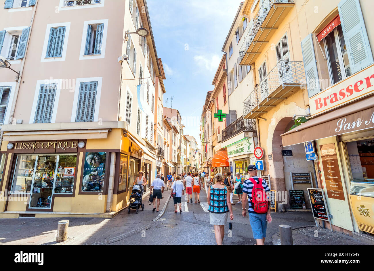 day view of main street Rue de la Republique with tourists in Antibes ...
