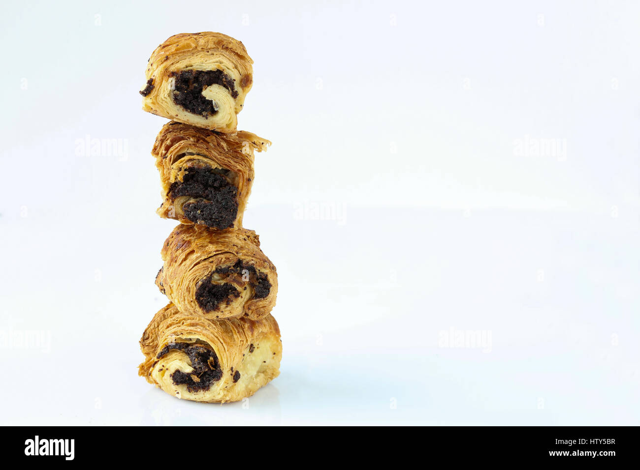 A tower of sweet rolls with poppies, which stand vertically on each ...
