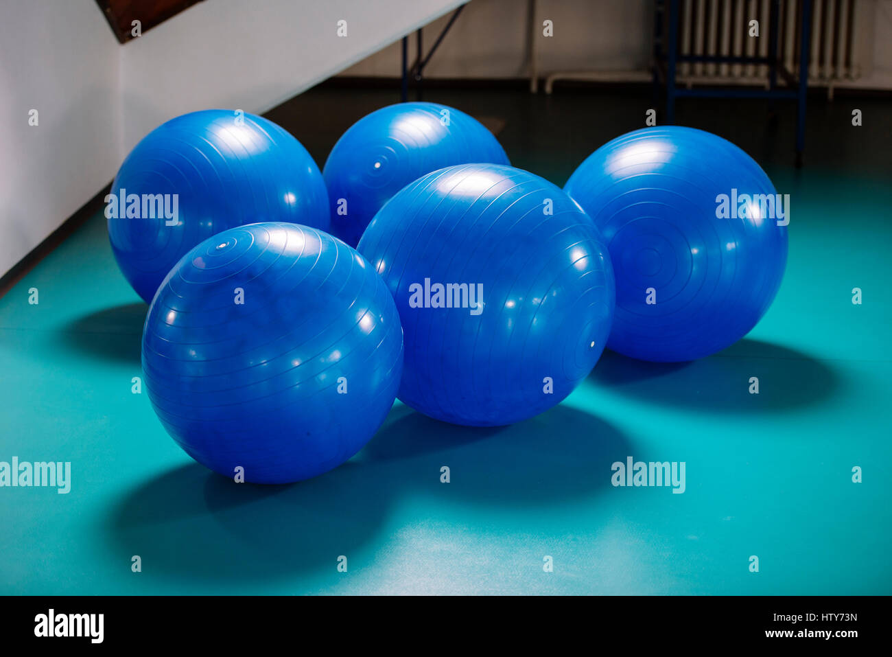 Group of blue pilates balls in the gym Stock Photo - Alamy