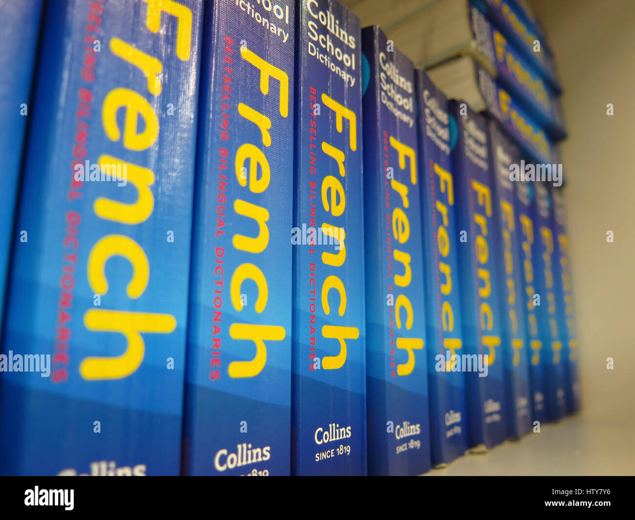 Line of French dictionaries on shelf Stock Photo - Alamy