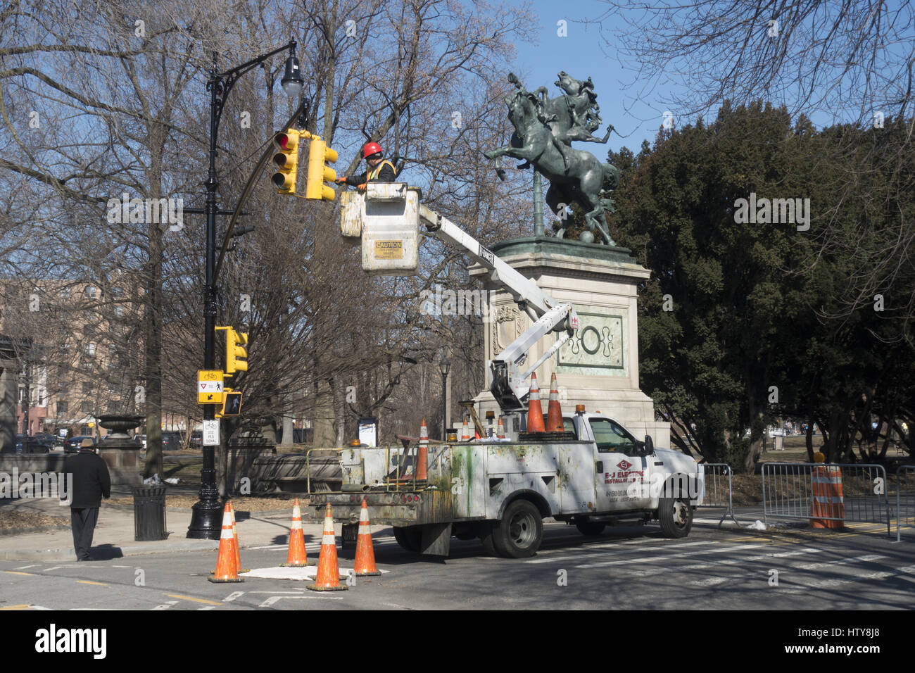 Worker replaces burned out traffic light in Brooklyn, NY at the ...