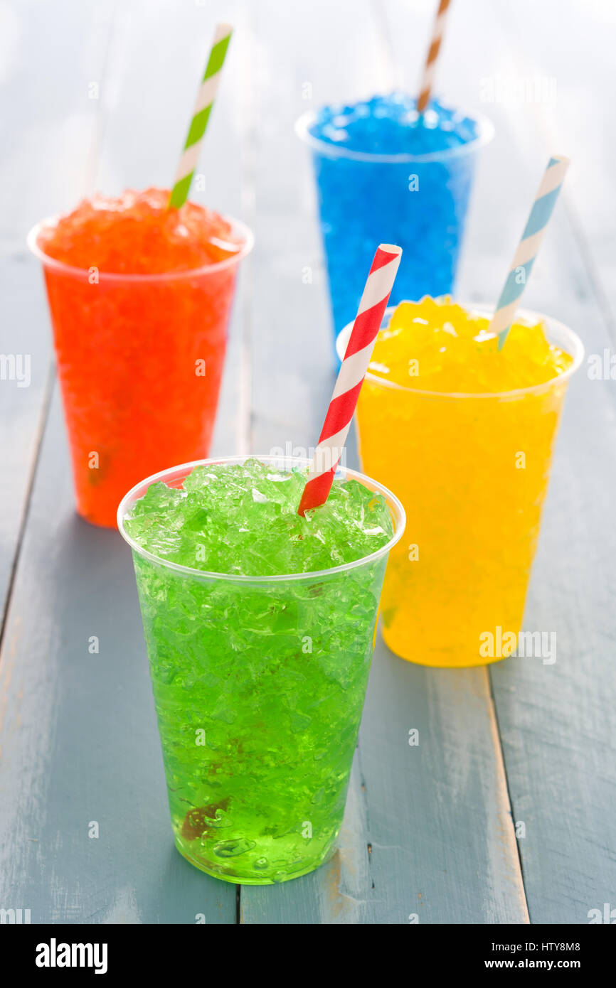 Colorful summer slushies on blue wooden background Stock Photo - Alamy