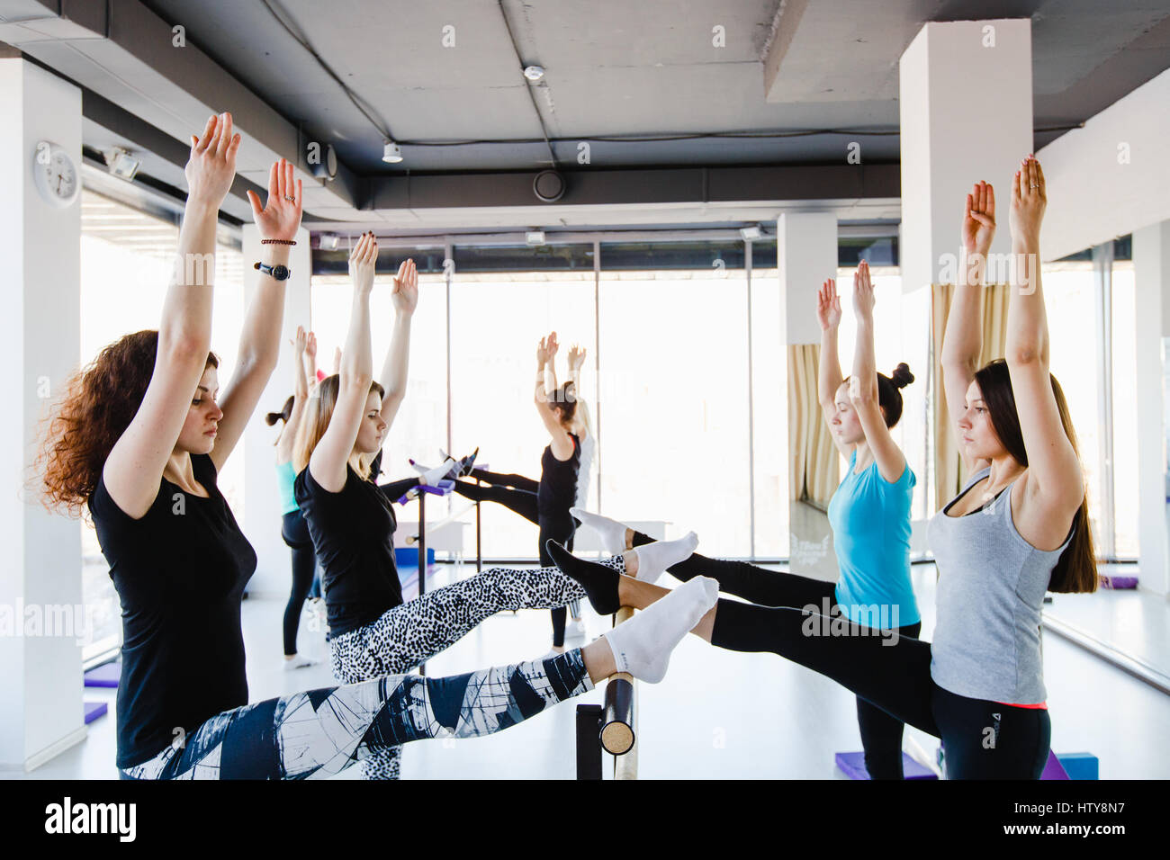Young women doing stretching exercises in the aerobics class on the ...