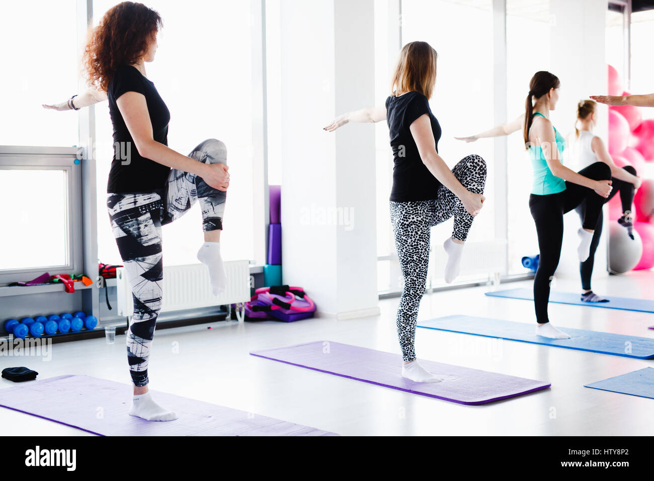 Young women doing stretching exercises in the aerobics class on the ...