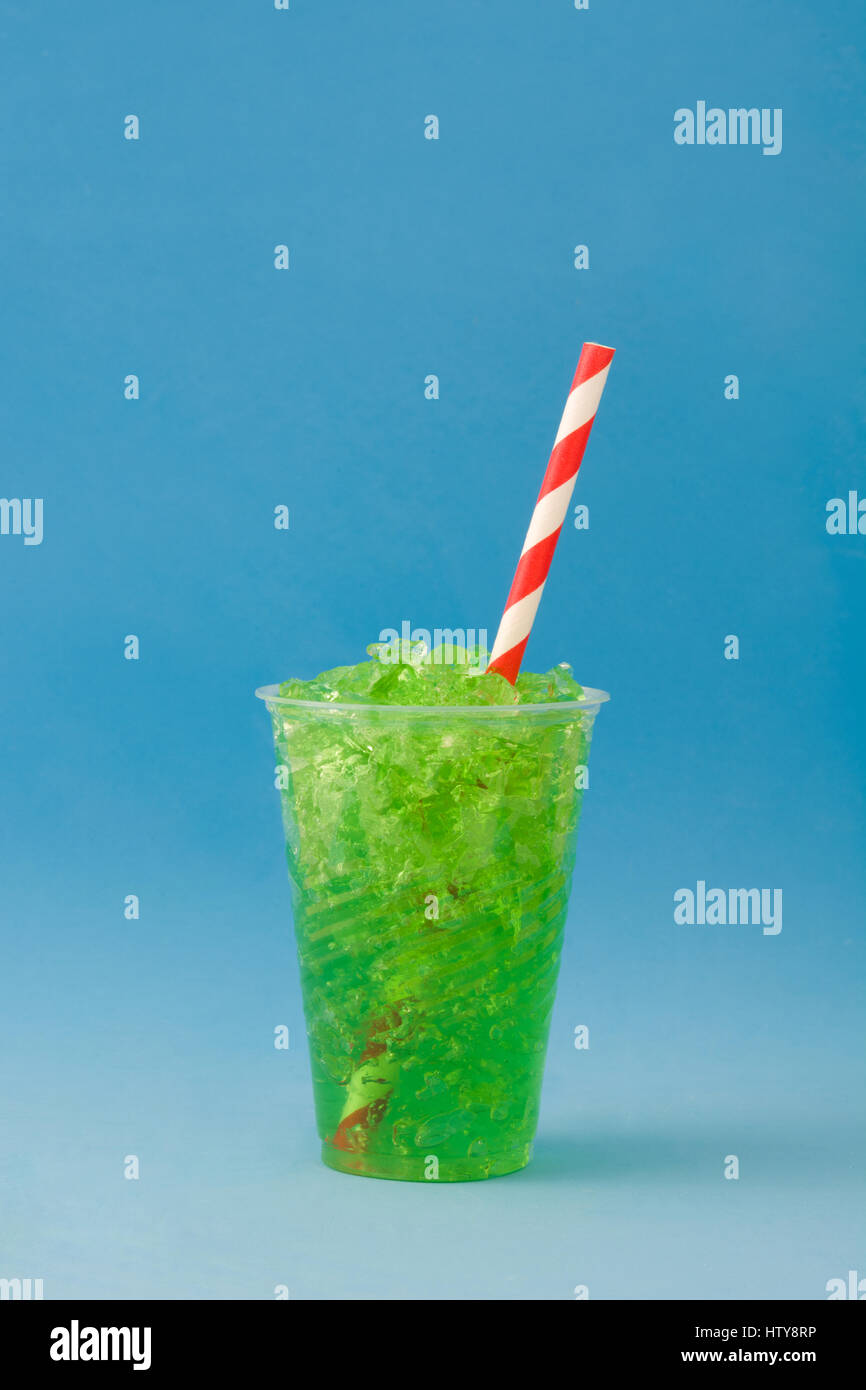 Green slushie. Blue background Stock Photo - Alamy
