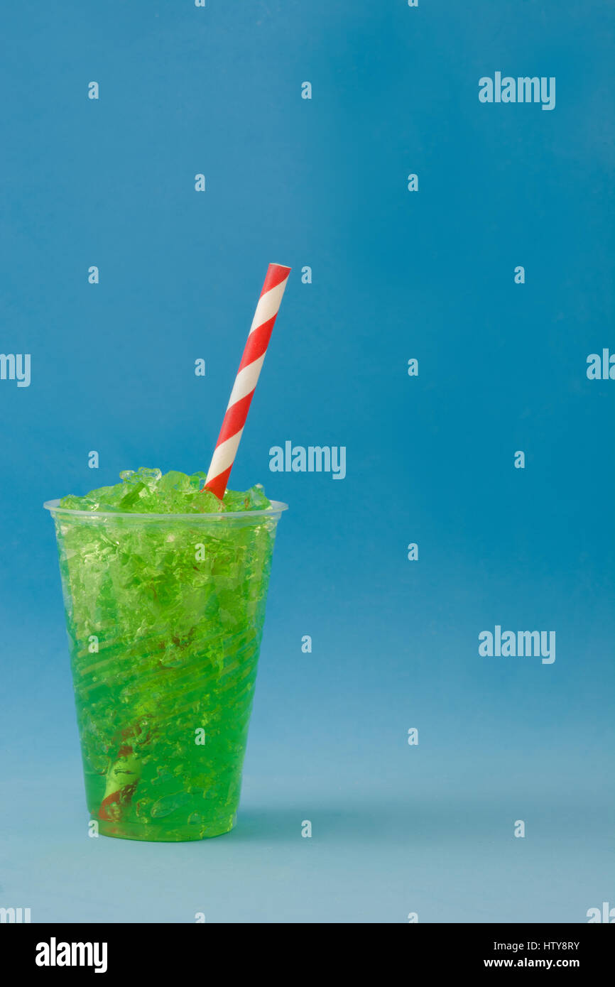 Green slushie. Blue background Stock Photo - Alamy