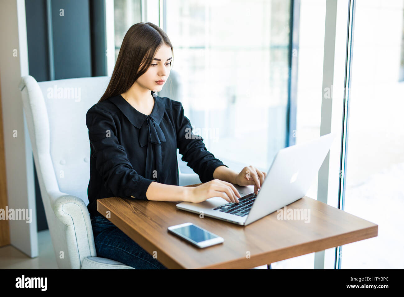 Female working on laptop in a cafe. girl hand using laptop in coffe ...