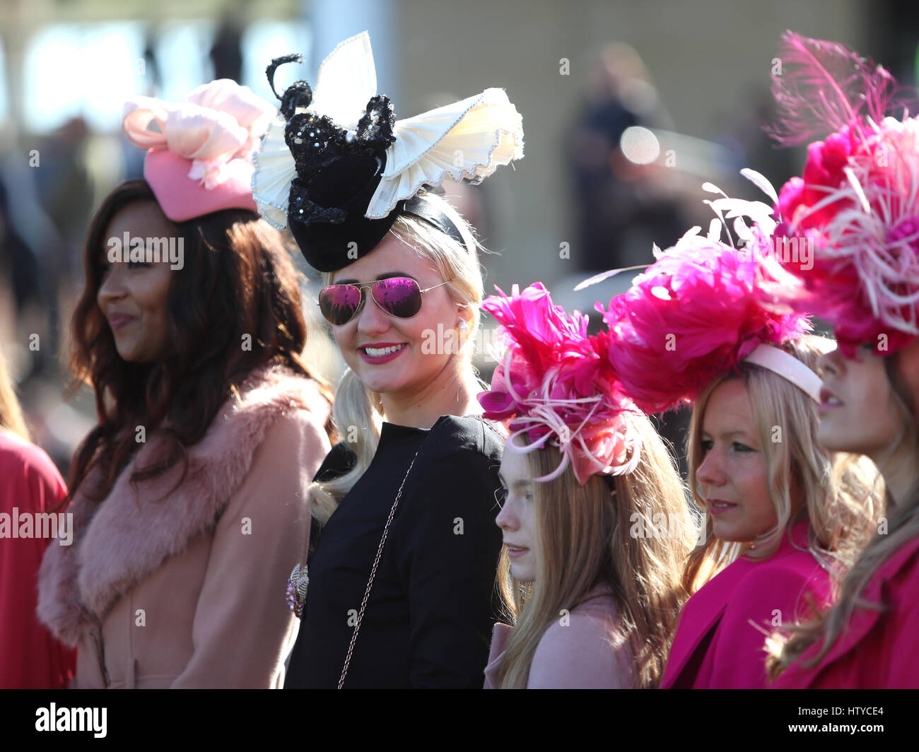 Female racegoers pose for photographers prior to the start of Ladies ...