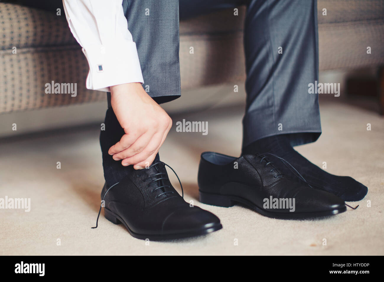 Man putting on shoes hi-res stock photography and images - Alamy