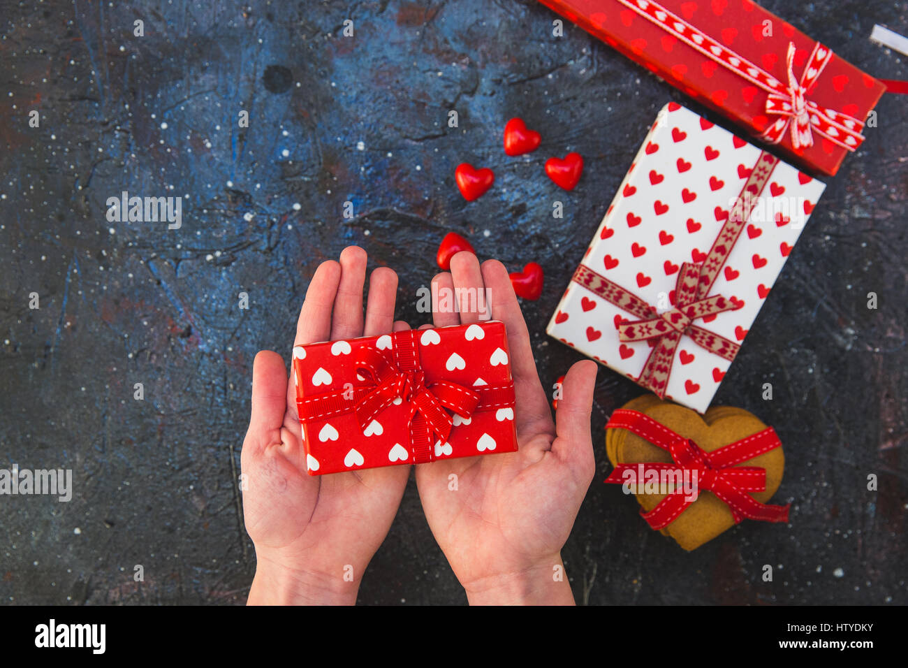 Girl's hands holding a wrapped gift Stock Photo - Alamy