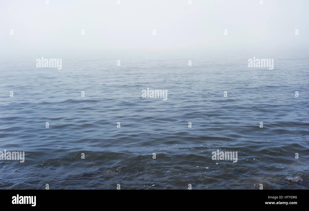 Fog over the sea waves Stock Photo - Alamy