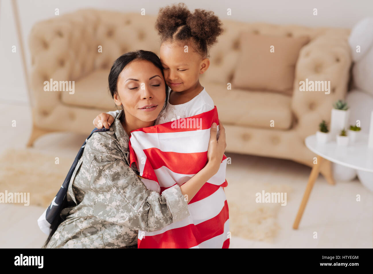 Passionate attached mom feeling very emotional Stock Photo - Alamy