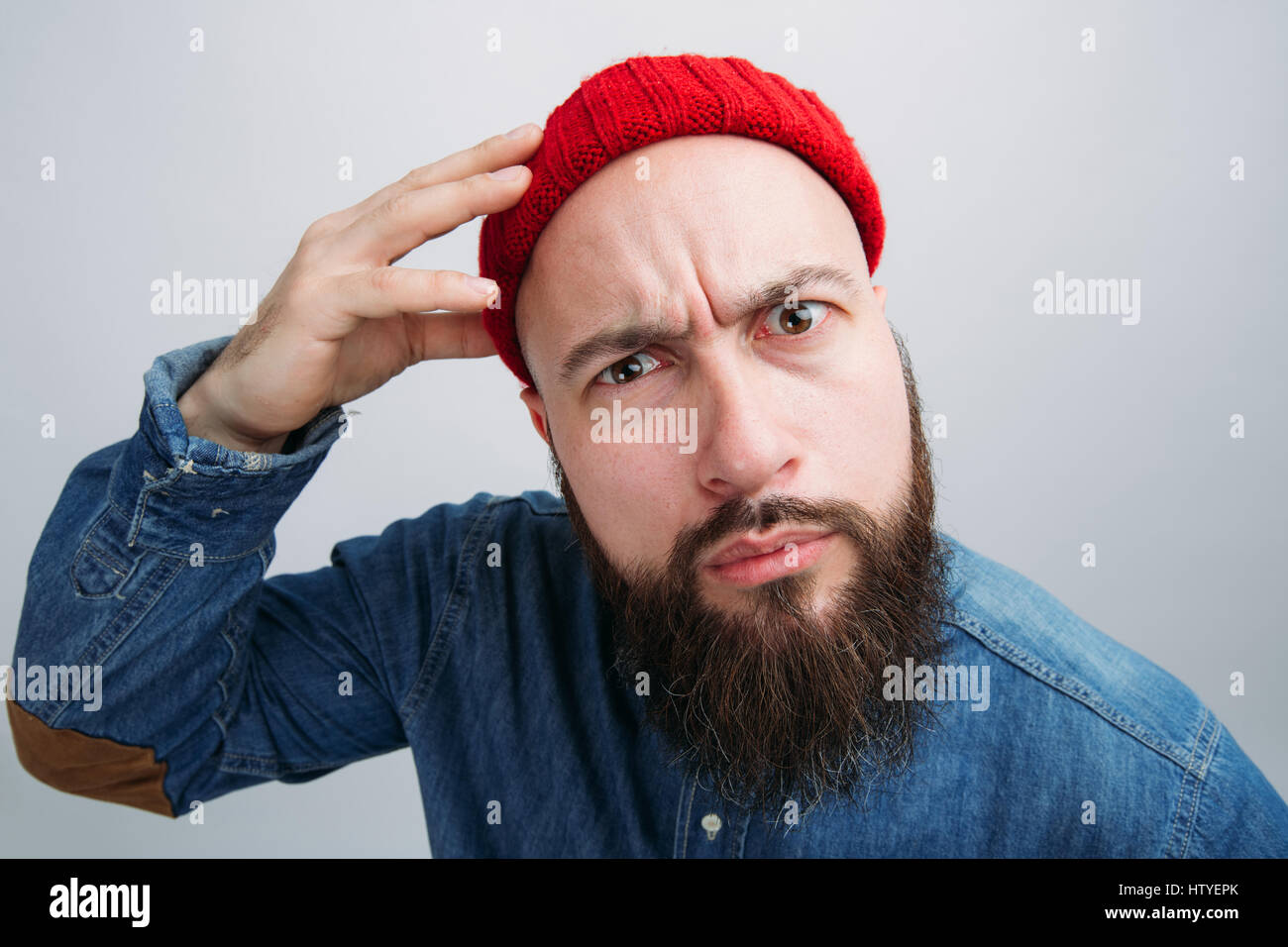 Portrait of a man scratching his head Stock Photo - Alamy