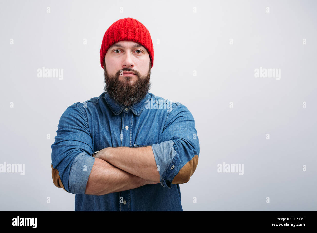Portrait of a man standing with his arms folded Stock Photo - Alamy