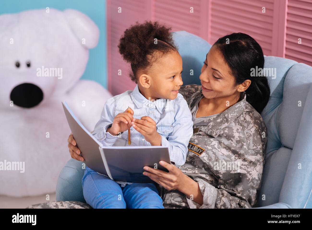 Admirable bright mother helping her daughter out Stock Photo - Alamy