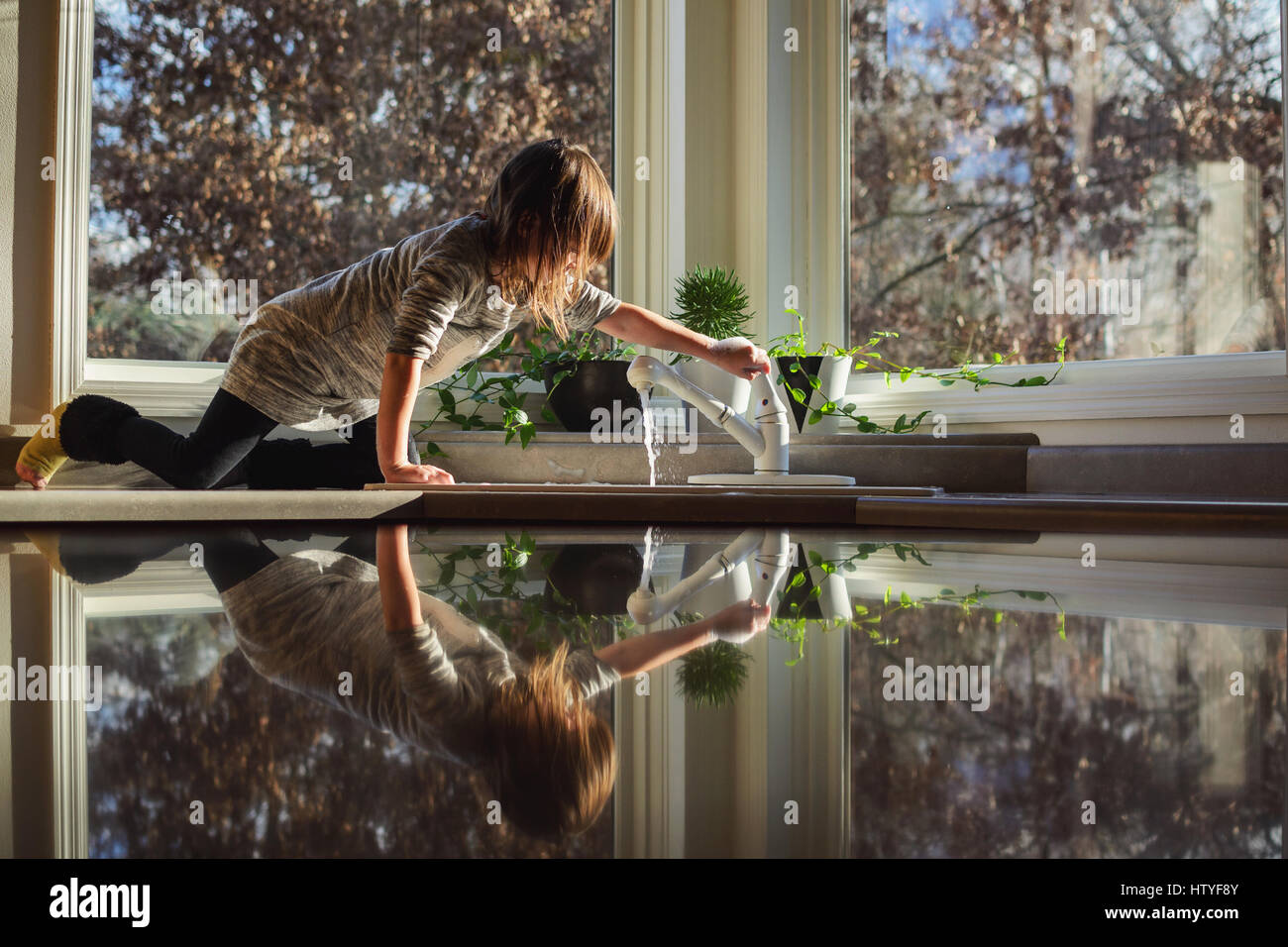 Child turning on tap hi-res stock photography and images - Alamy