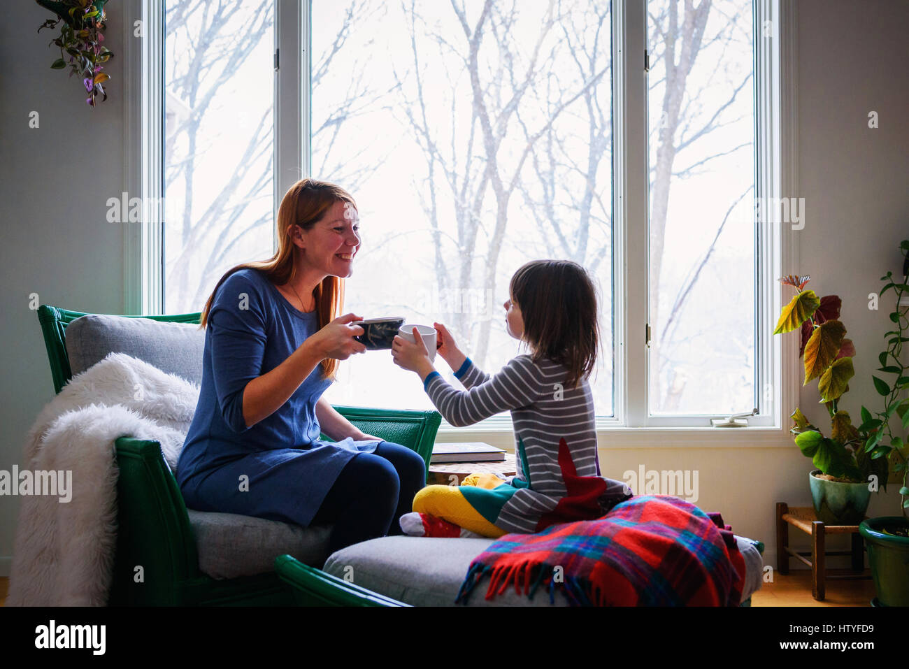 Mother and daughter toasting with cup of tea Stock Photo - Alamy