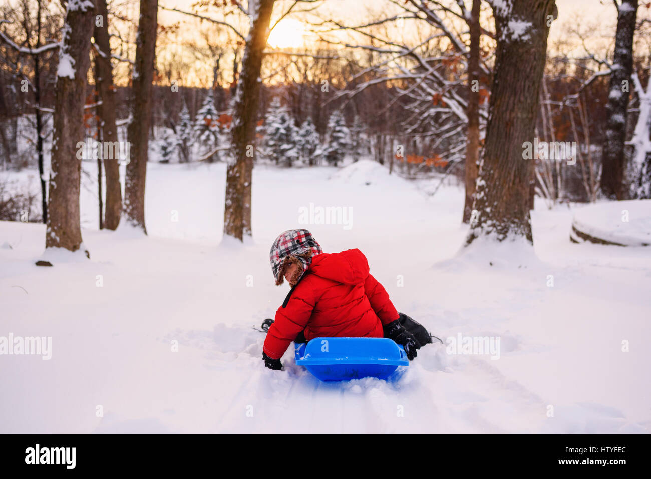 Boy tobogganing down hill hi-res stock photography and images - Alamy
