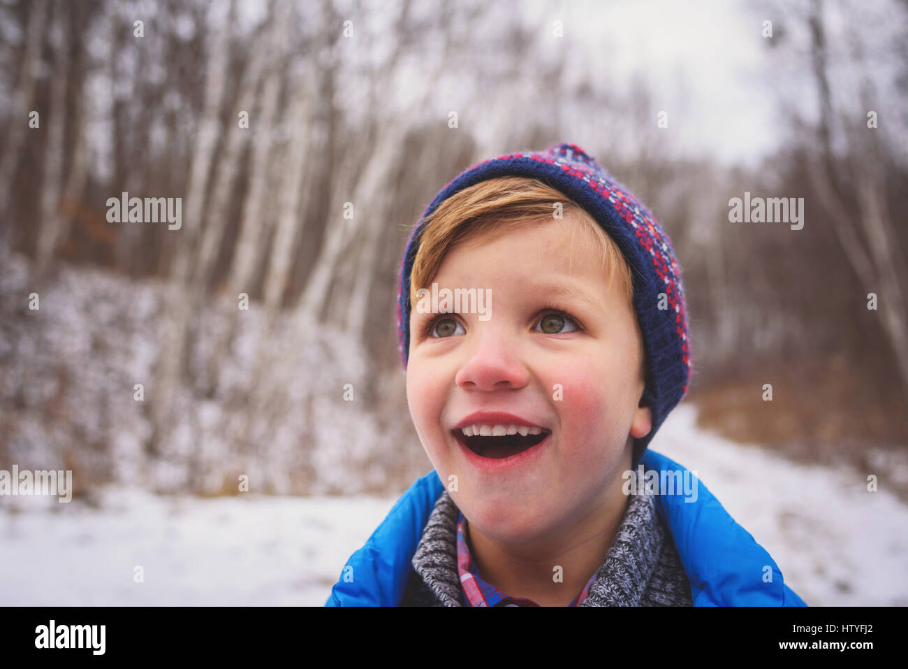 Portrait of a smiling boy in snow Stock Photo - Alamy