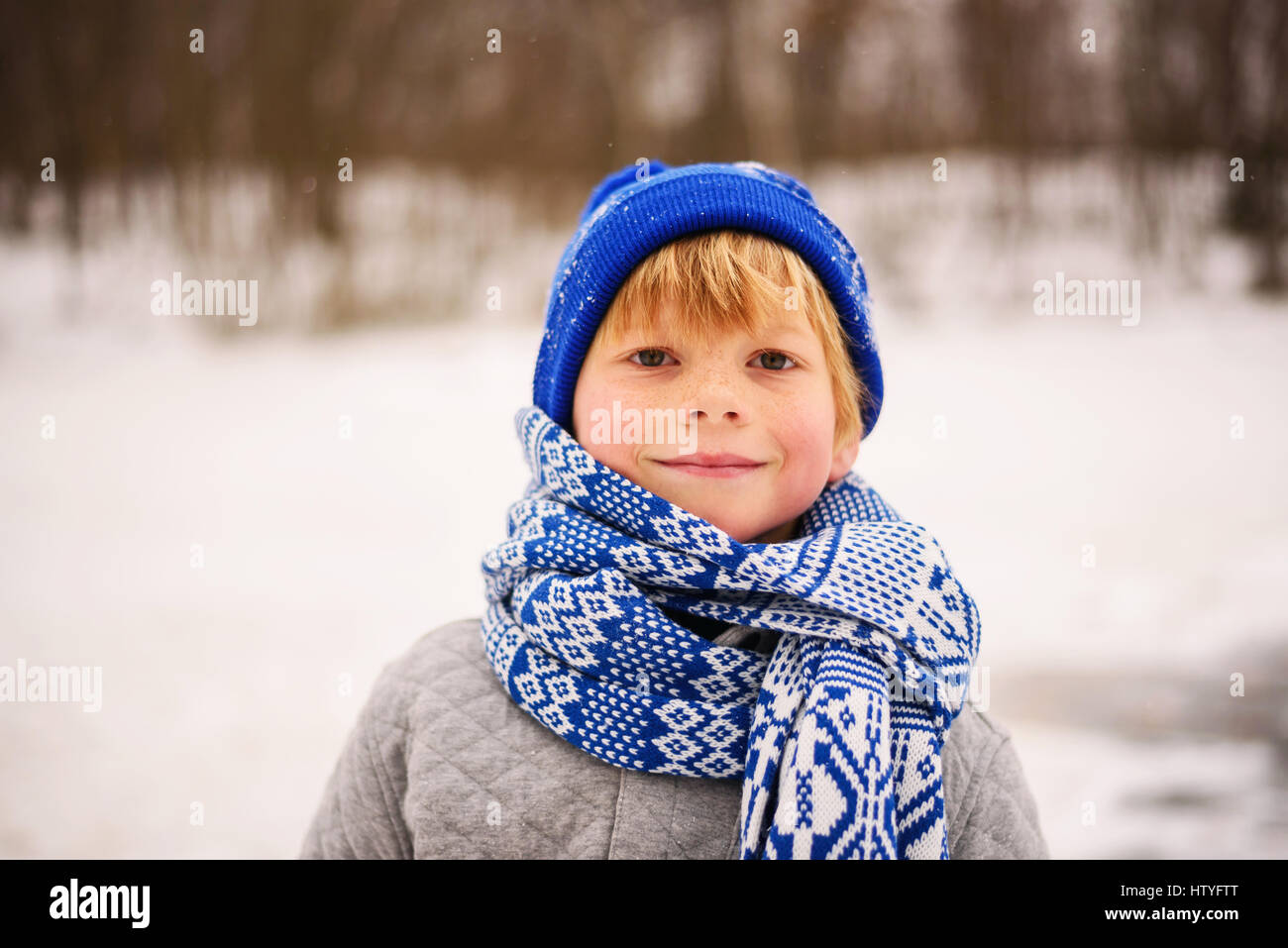 Portrait of a boy standing in snow Stock Photo - Alamy