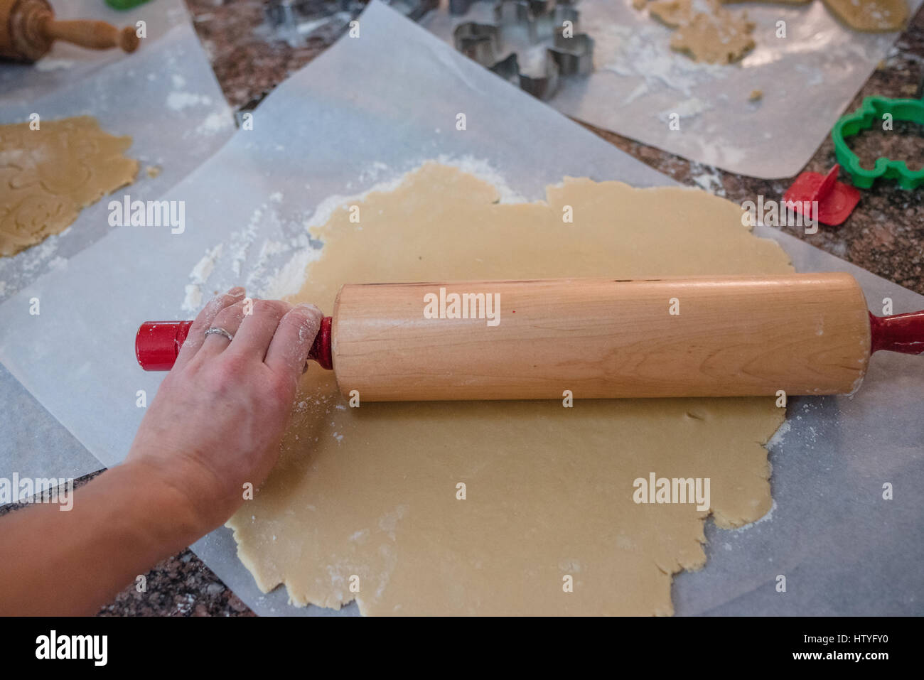 Woman rolling out dough for Christmas cookies Stock Photo - Alamy
