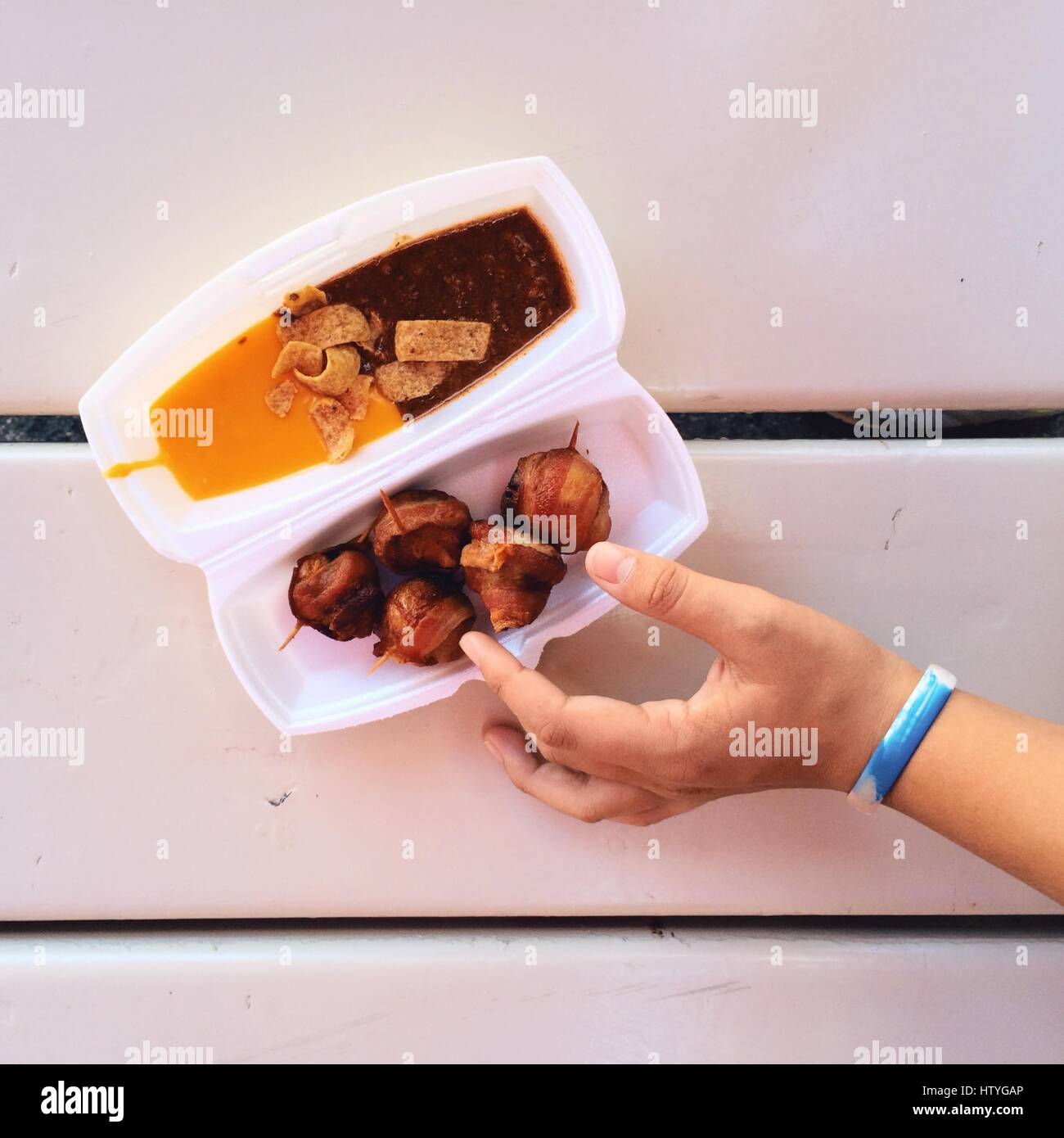 Human hand eating tex-mex food Stock Photo - Alamy