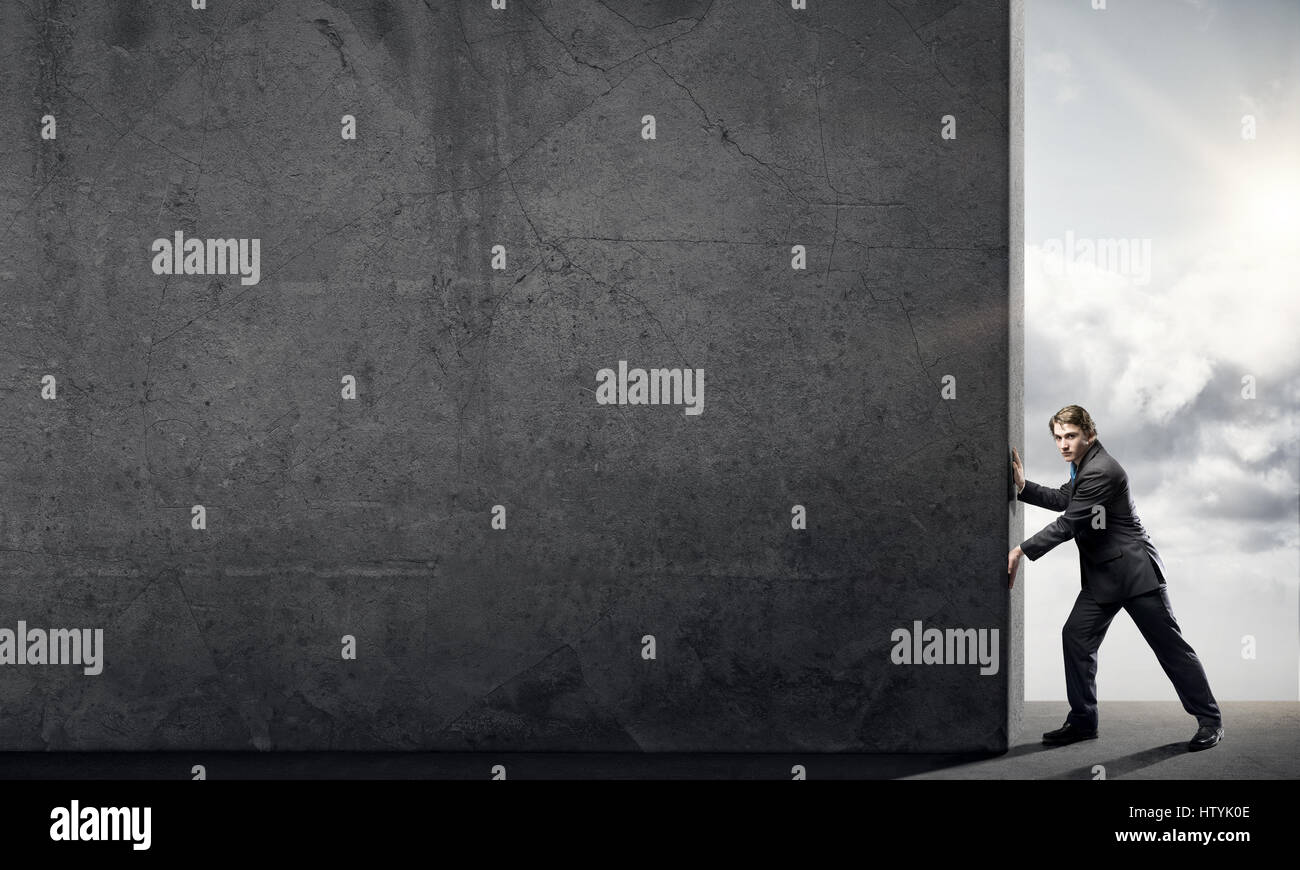 Businessman push wall Stock Photo - Alamy