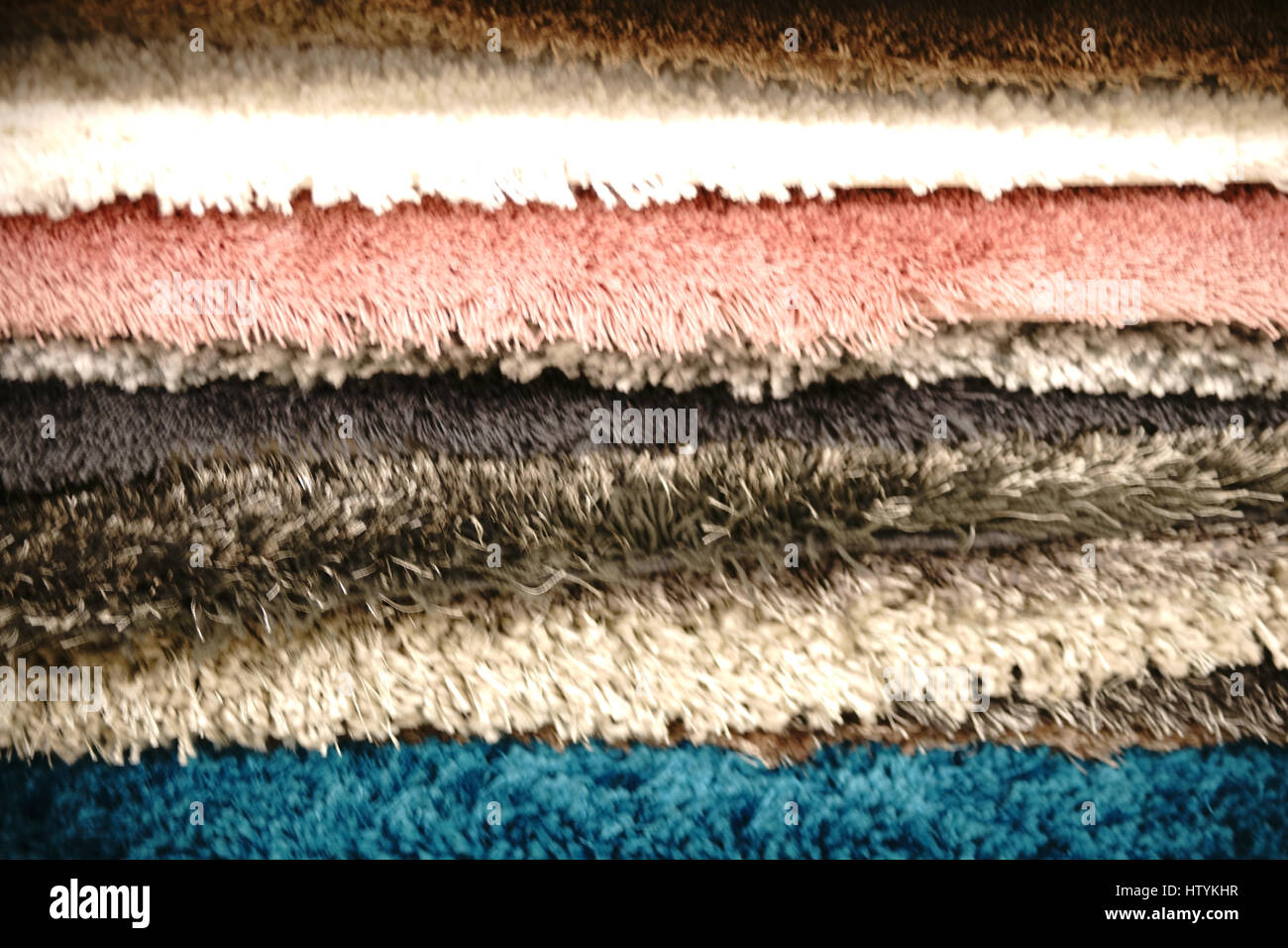 The close-up of fabric fluff and floor coverings of stacked carpets ...