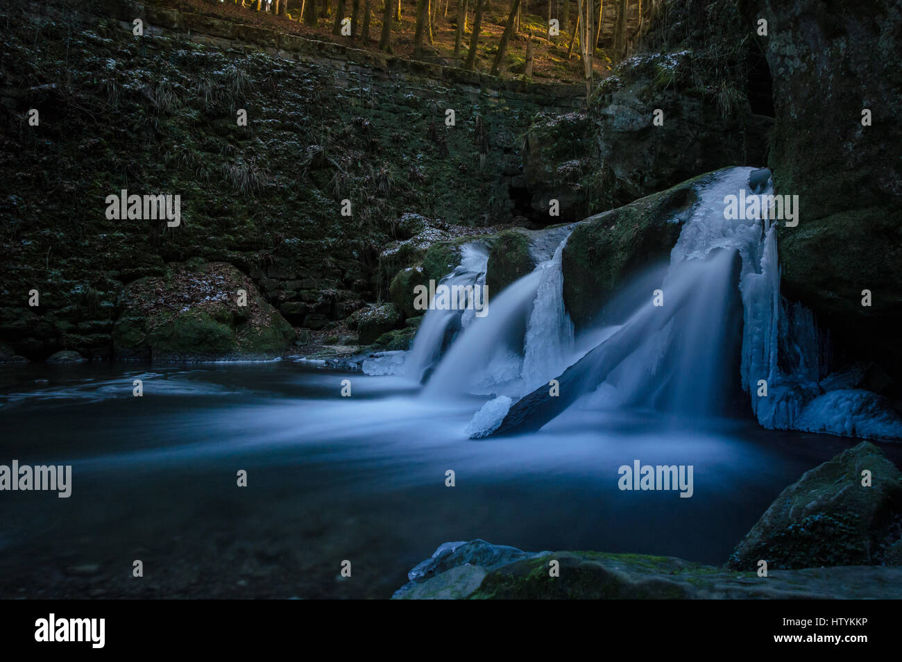 Frozen waterfall under old stone bridge Stock Photo - Alamy