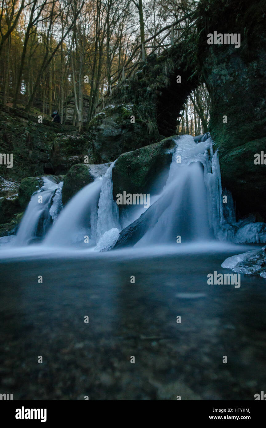 Frozen waterfall under old stone bridge Stock Photo - Alamy