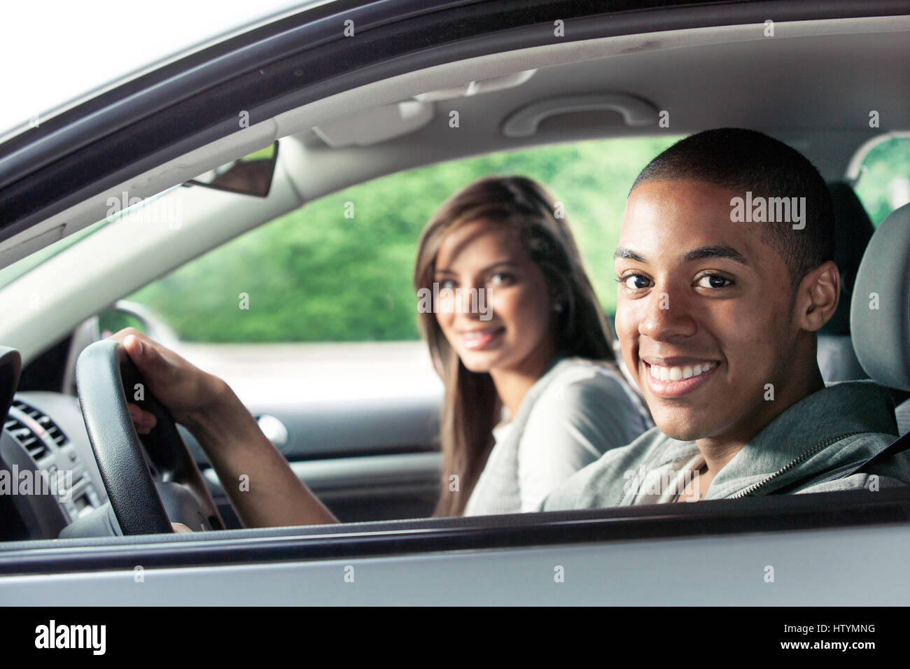 Teenagers driving car Stock Photo - Alamy