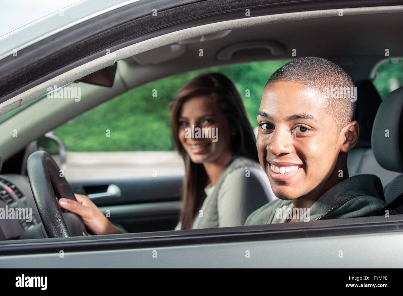 Teenagers driving car Stock Photo - Alamy