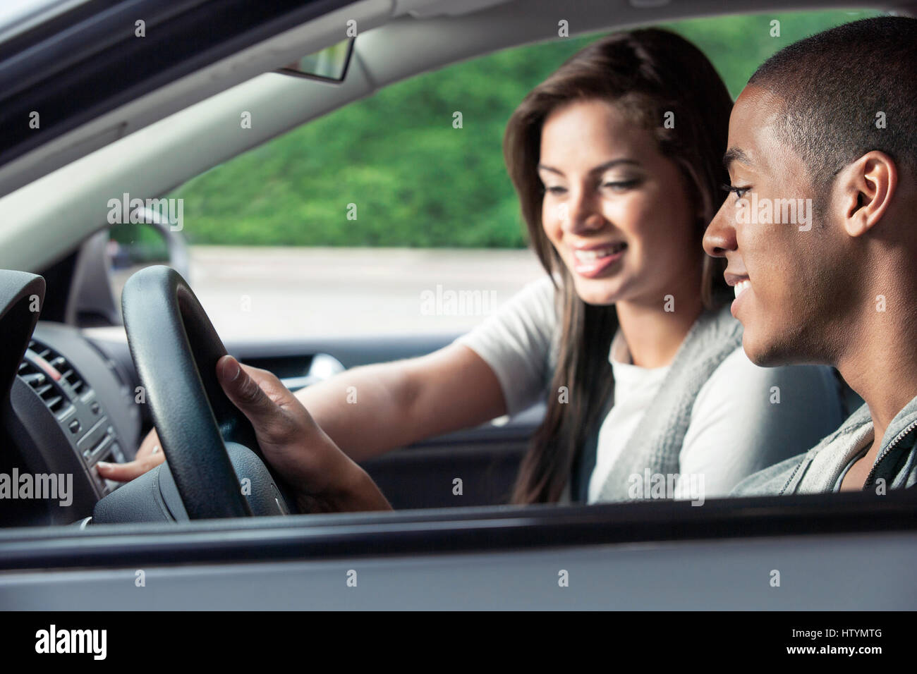Teenagers driving car Stock Photo - Alamy