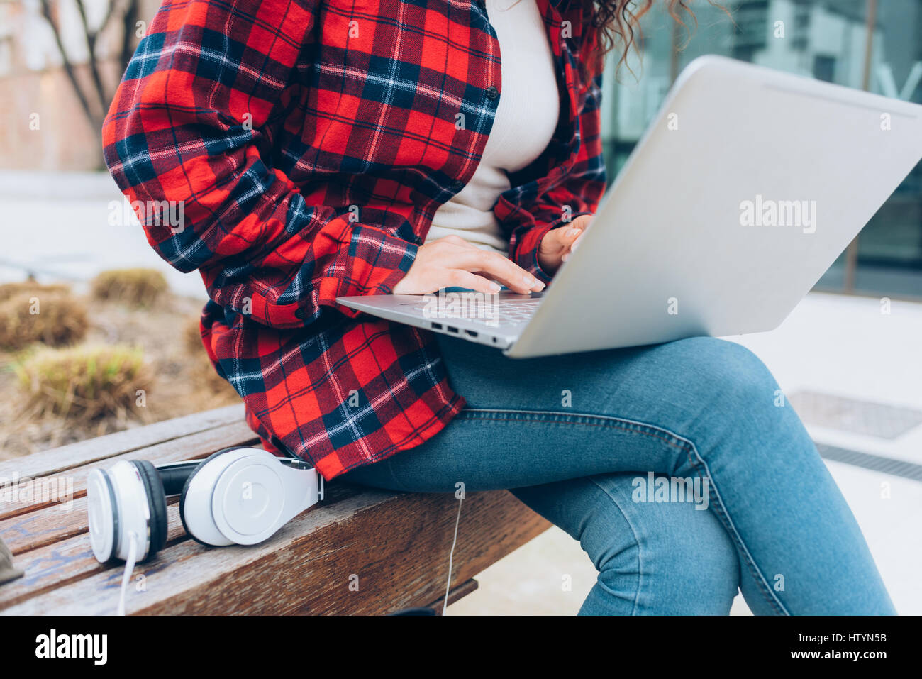 Close up on the hand of young woman tapping the keyboard of a computer ...