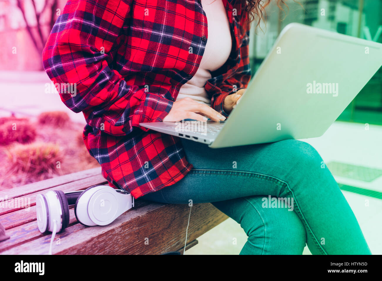 Close up on the hand of young woman tapping the keyboard of a computer ...