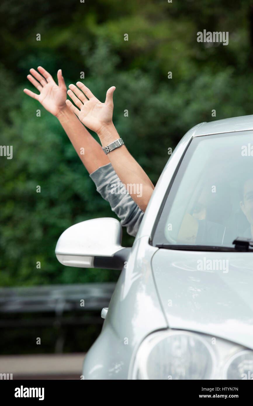 Hands sticking out of car Stock Photo - Alamy