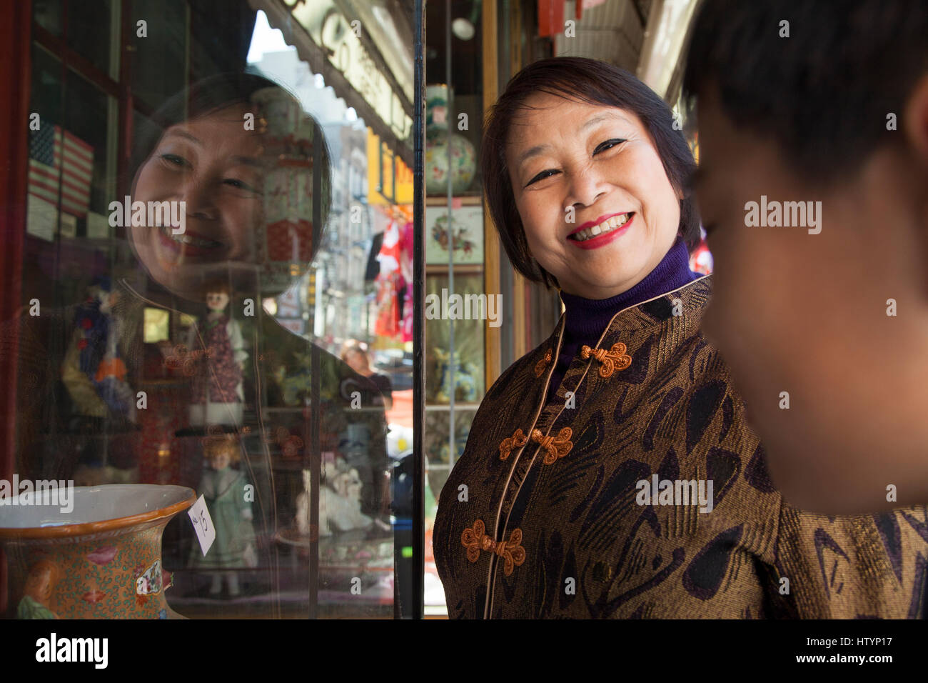 Asian family in front of store Stock Photo - Alamy