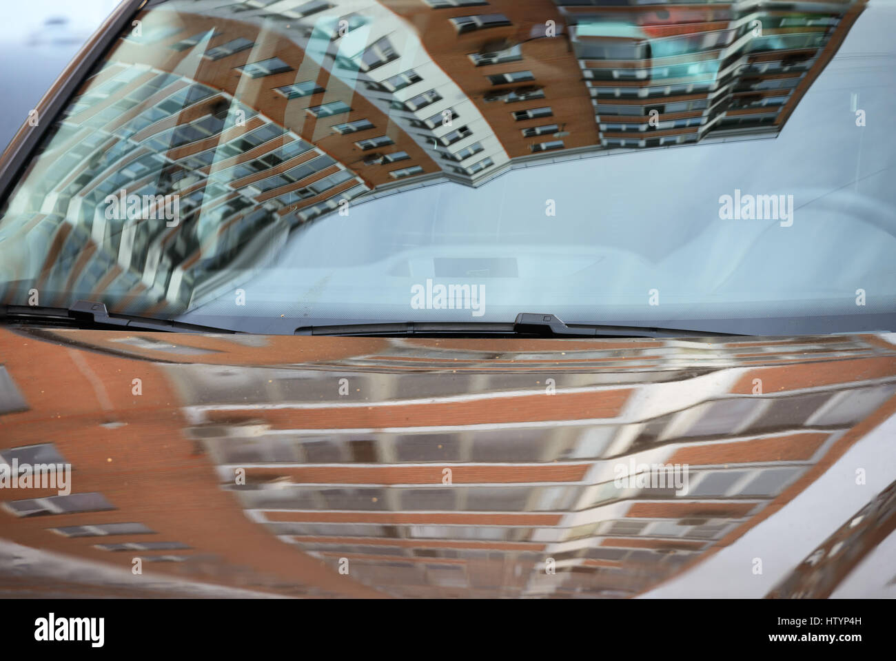 Close-up reflections of multi-storey residential building in surfaces ...
