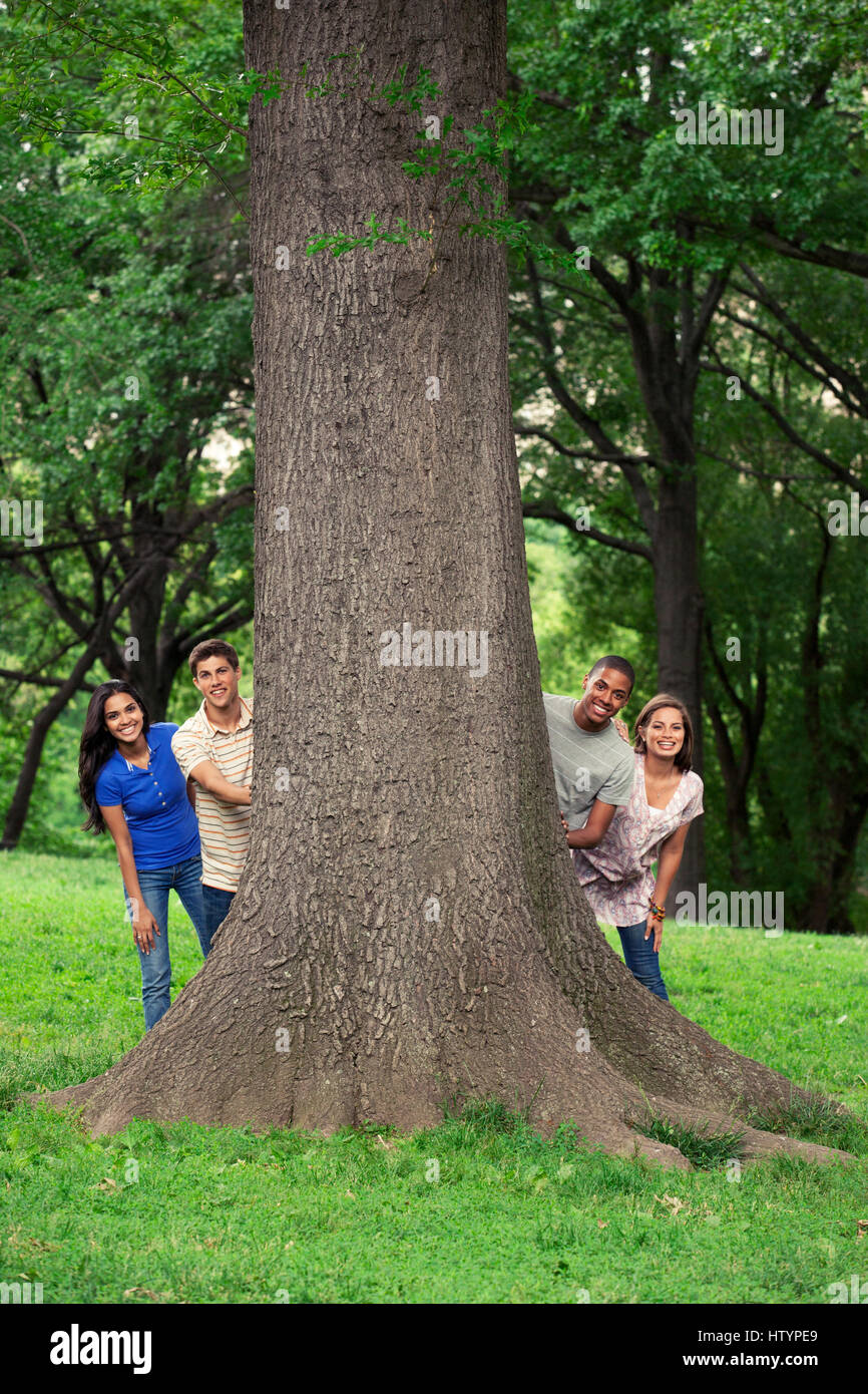 Teenage friends spending time together at tree Stock Photo - Alamy