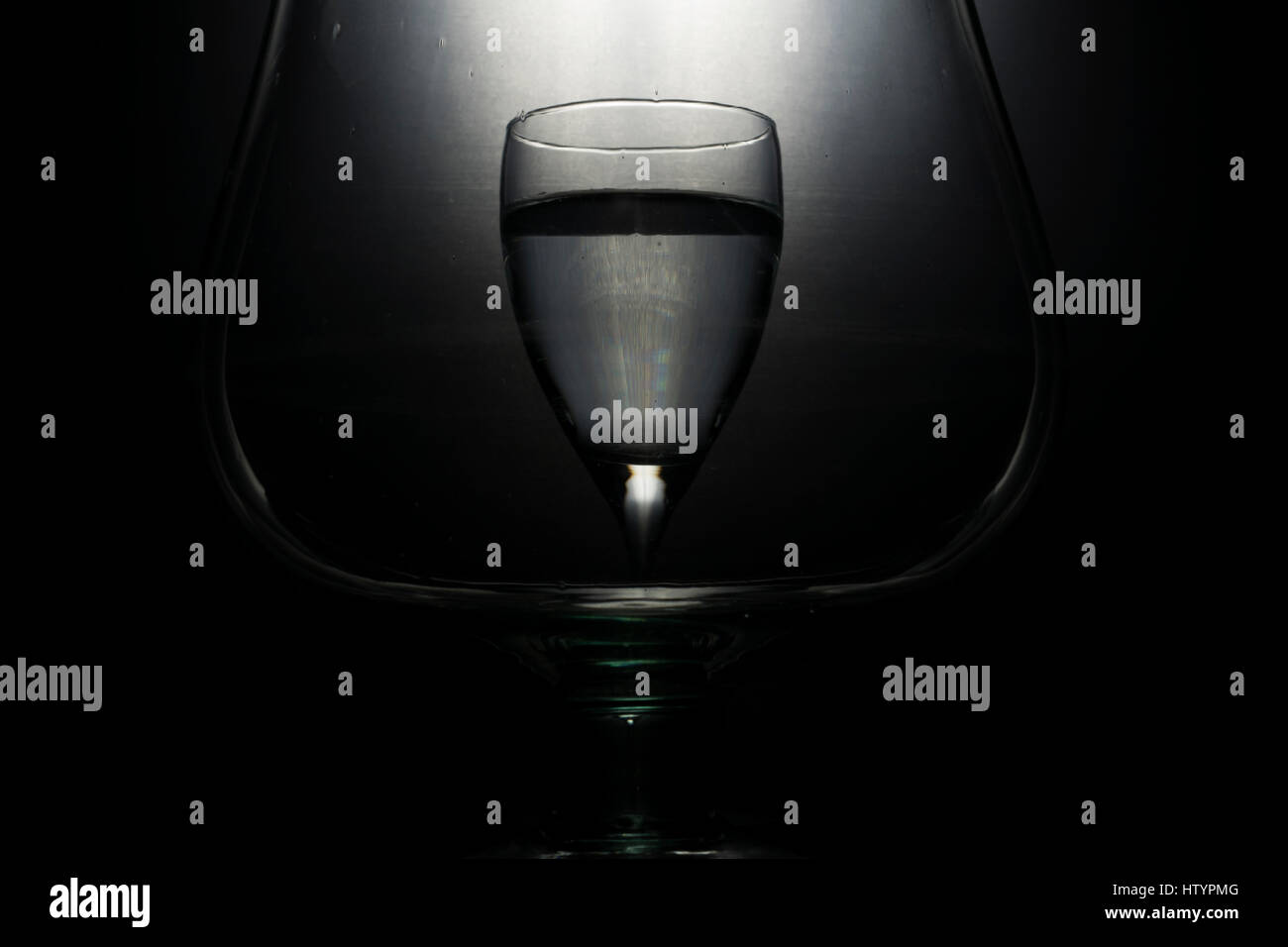 Glass of water and large glass silhouette Stock Photo - Alamy