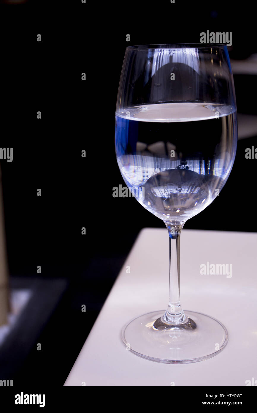 Glass of water resting on a restaurant table Stock Photo - Alamy