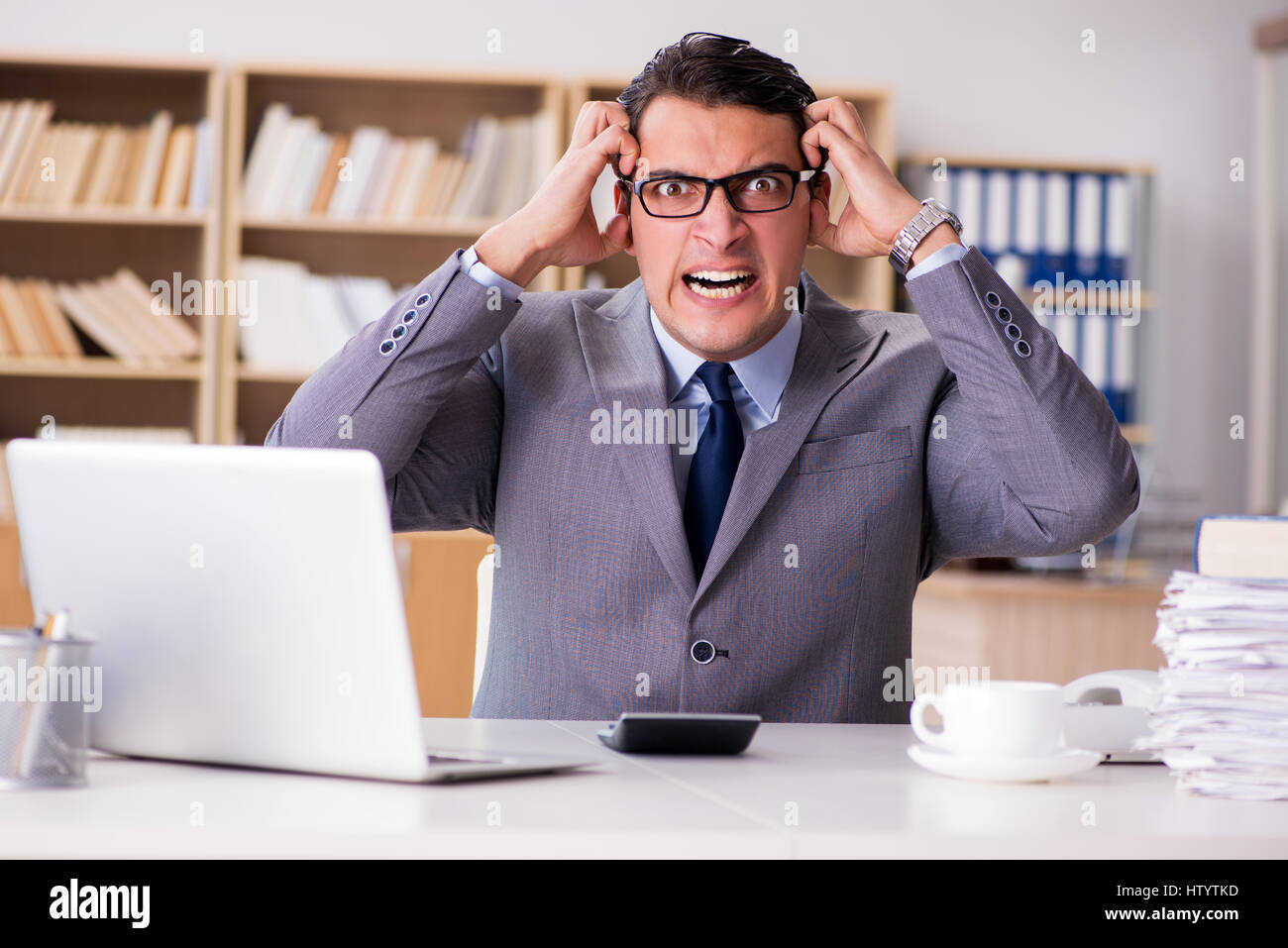 Angry businessman working in the office Stock Photo - Alamy
