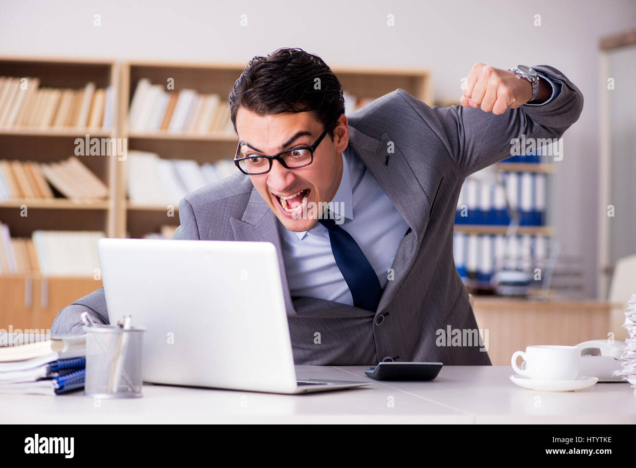 Angry businessman working in the office Stock Photo - Alamy