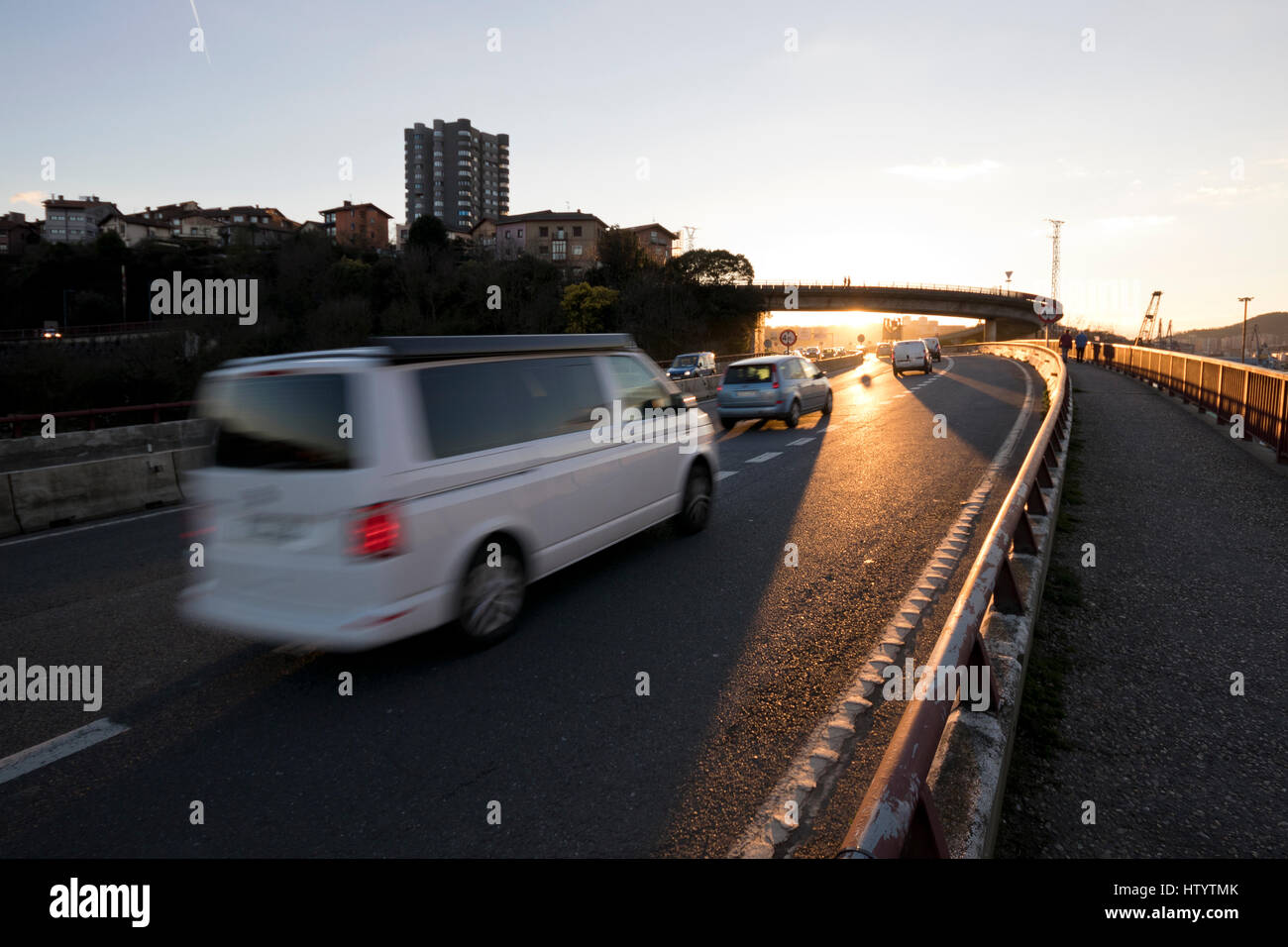 Long car shadows creating a channel to sunset reflecting light on a ...