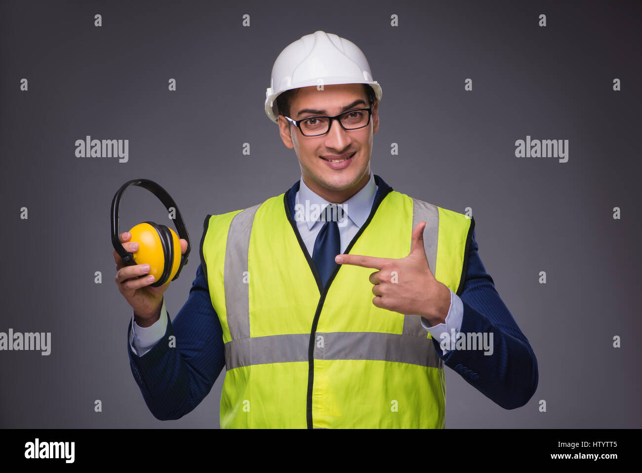 Man wearing hard hat and construction vest Stock Photo - Alamy