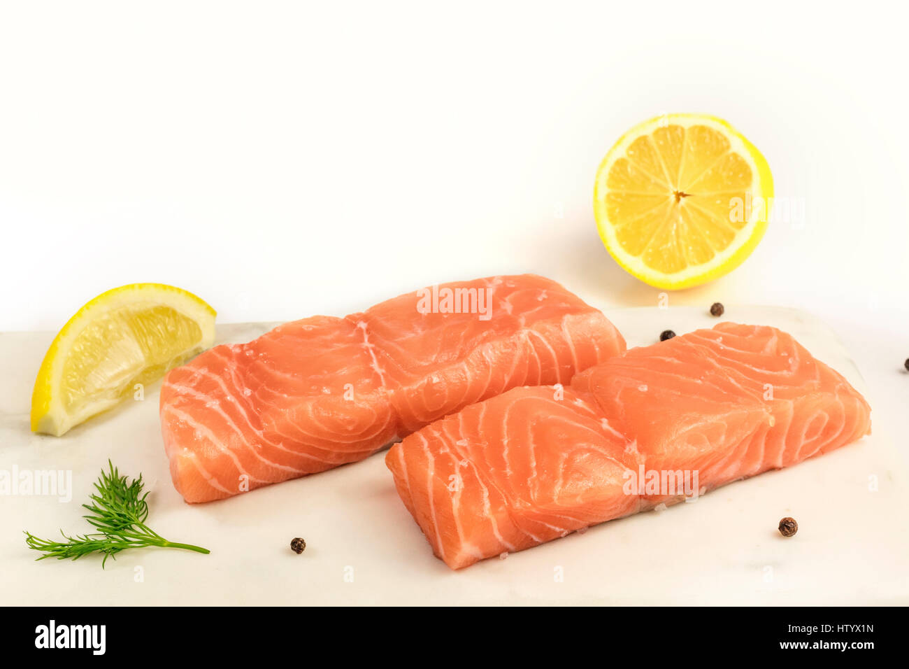 Two slices of salmon on white background with copyspace Stock Photo - Alamy