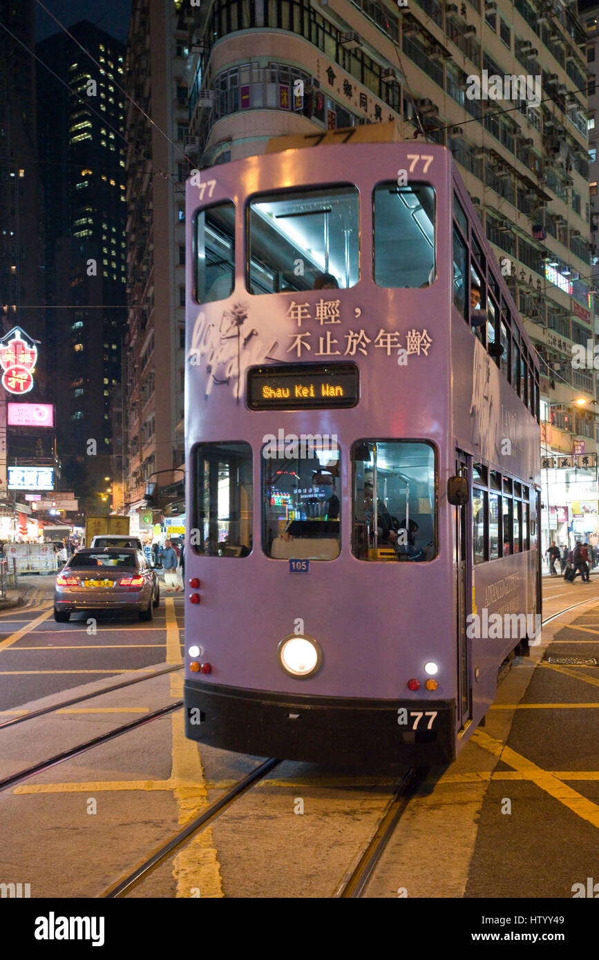 A tram crossing a busy intersection for pedestrians crossing the street ...