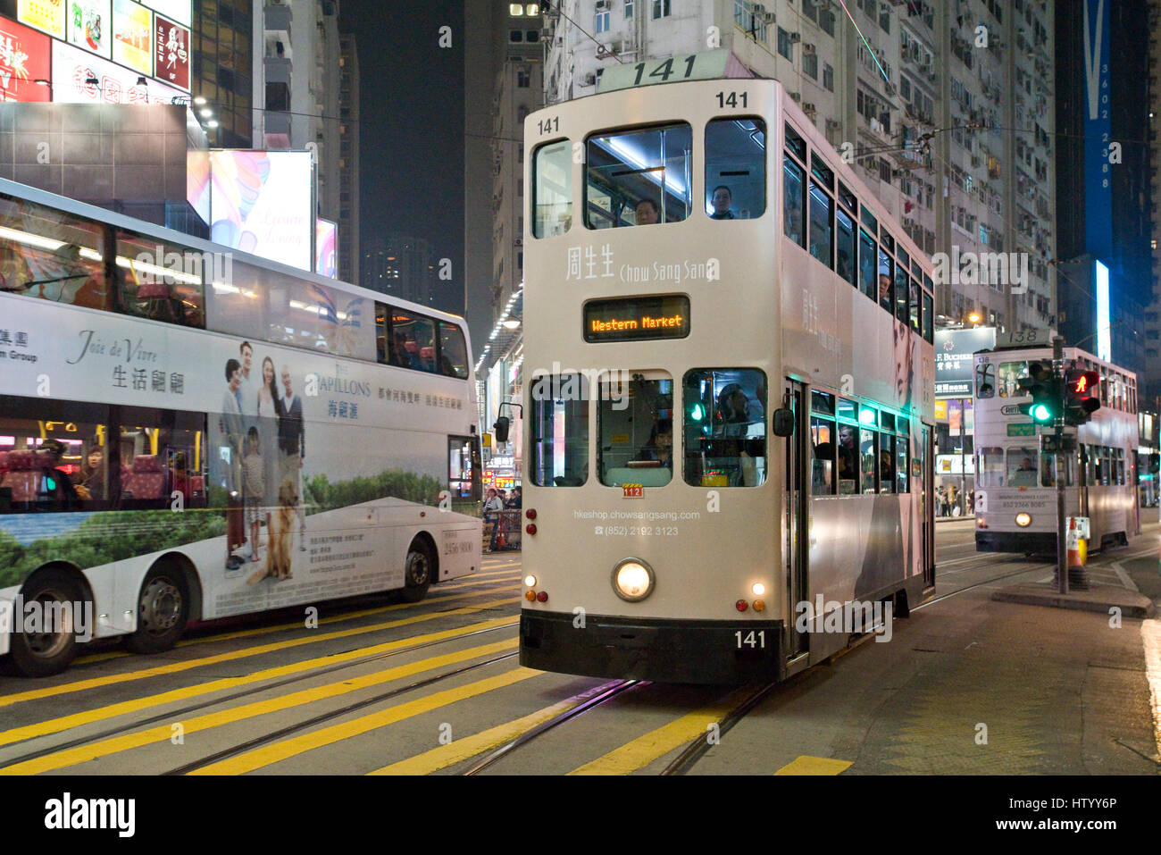 A tram crossing a busy intersection for pedestrians crossing the street ...